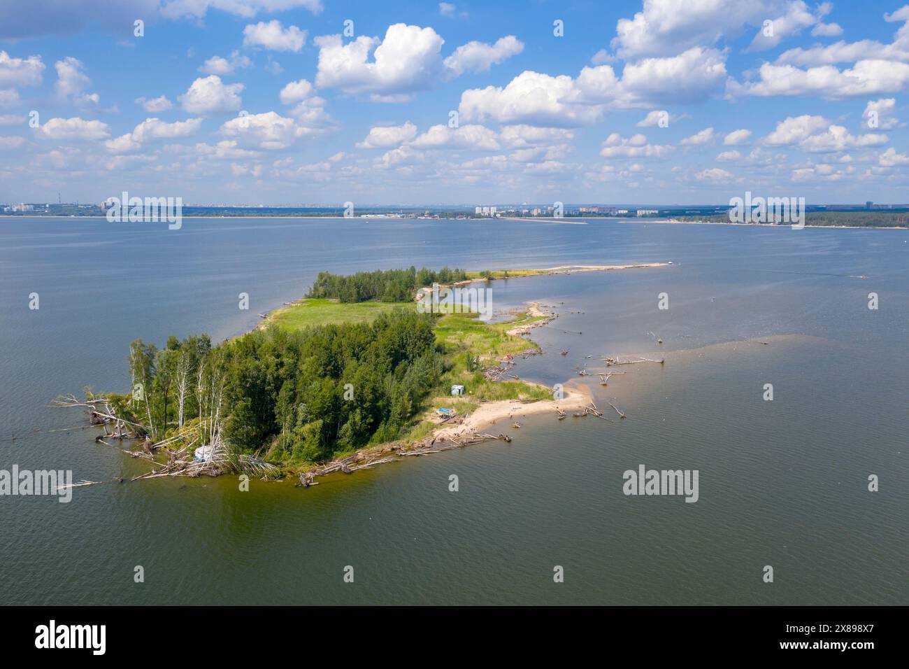 Aerial view of the sandy spit of an uninhabited island with a forest ...