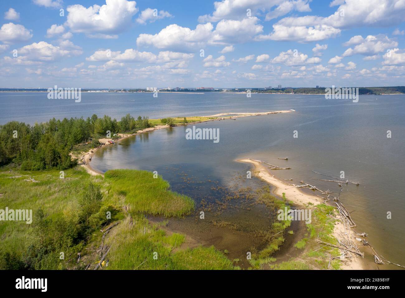 Aerial view of the sandy spit of an uninhabited island with a forest ...