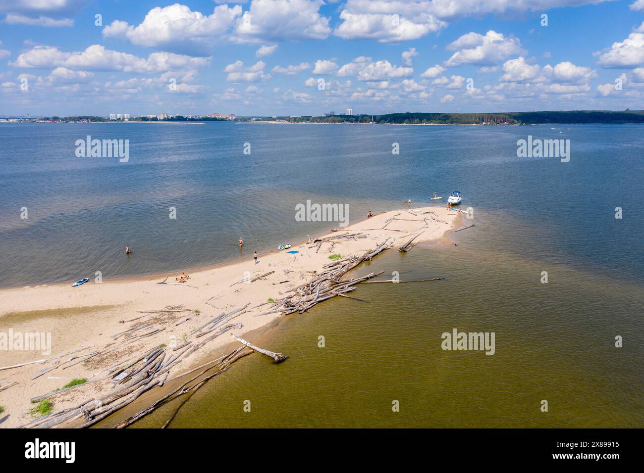 Aerial view of the sandy spit of an uninhabited island and a city with ...