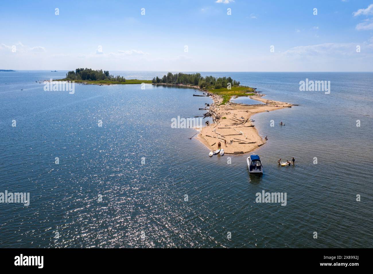 Aerial view of the sandy spit of an uninhabited island with a forest ...