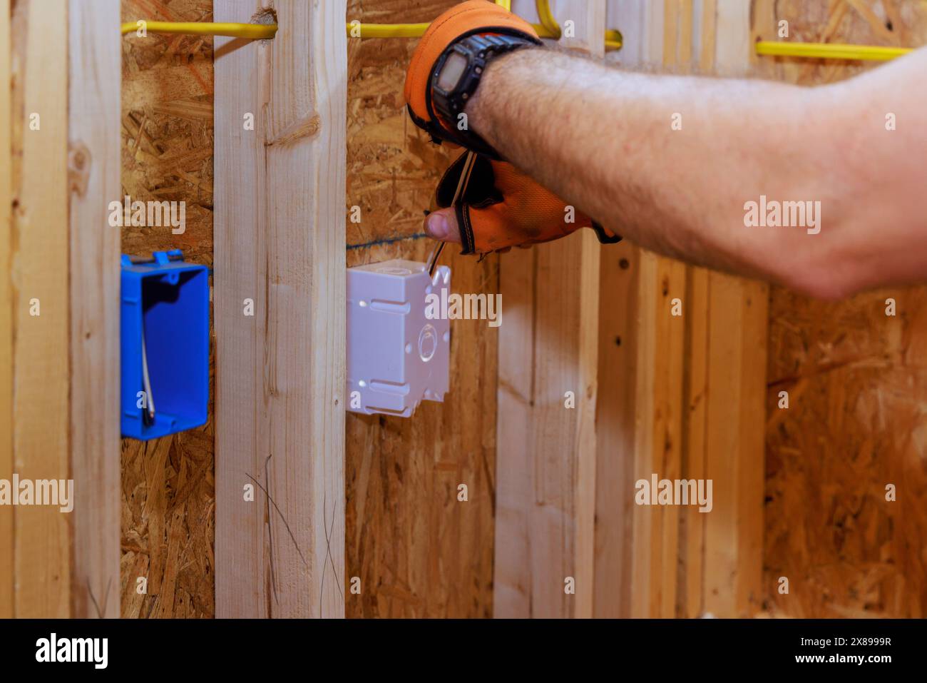 During construction of new building, an electrician connects wires to ...