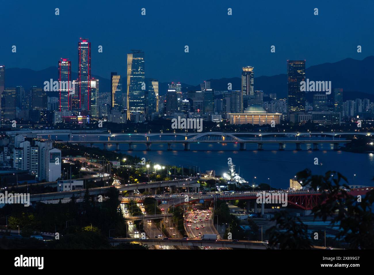 A night view of the National Assembly building and high-rise buildings ...