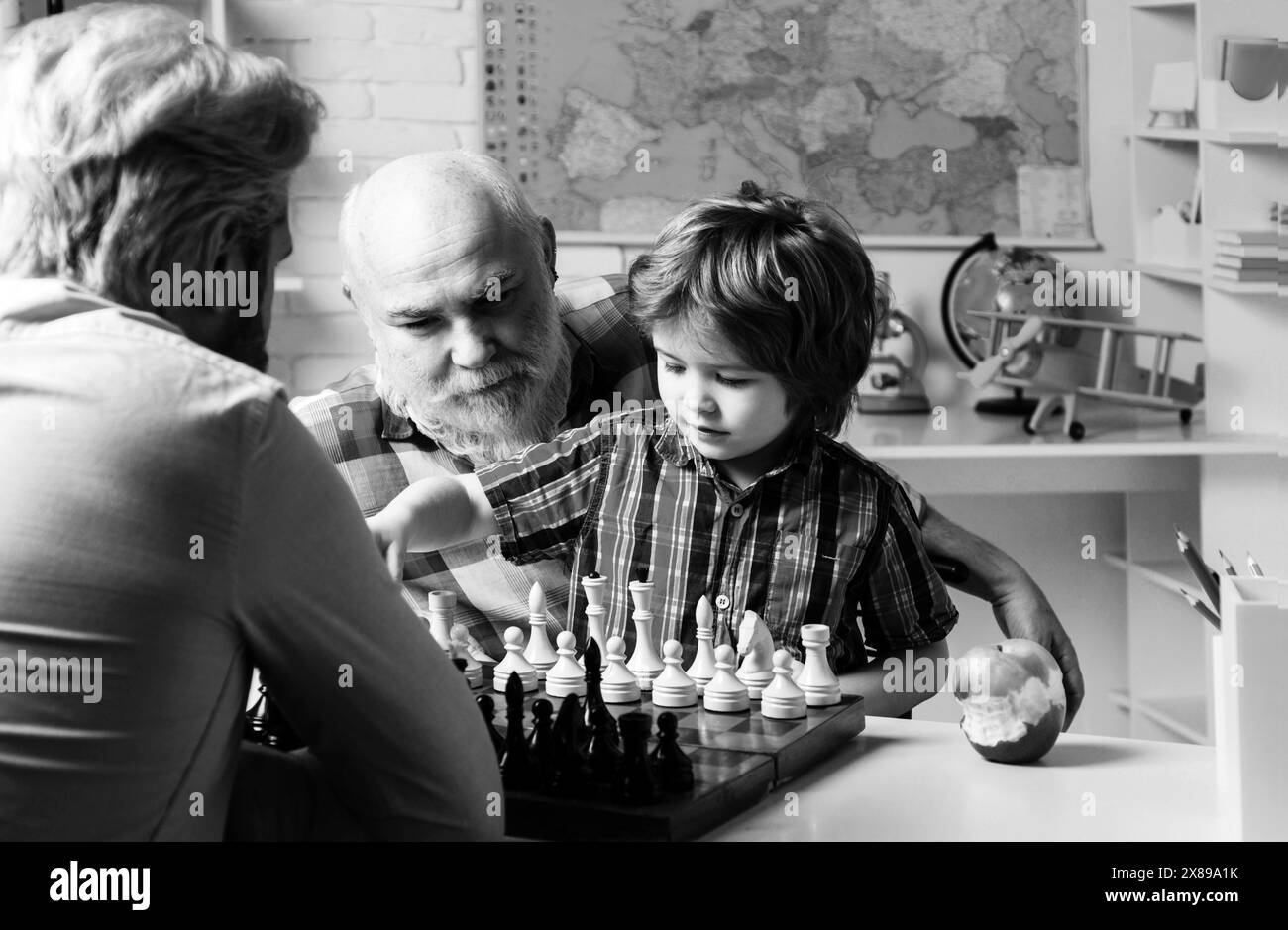 Grandfather boy playing game chess Black and White Stock Photos ...