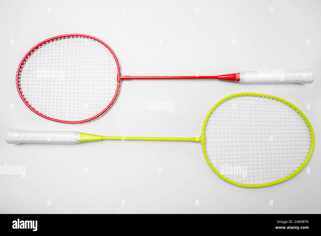 Overhead view of two colorful badminton rackets with red and yellow ...
