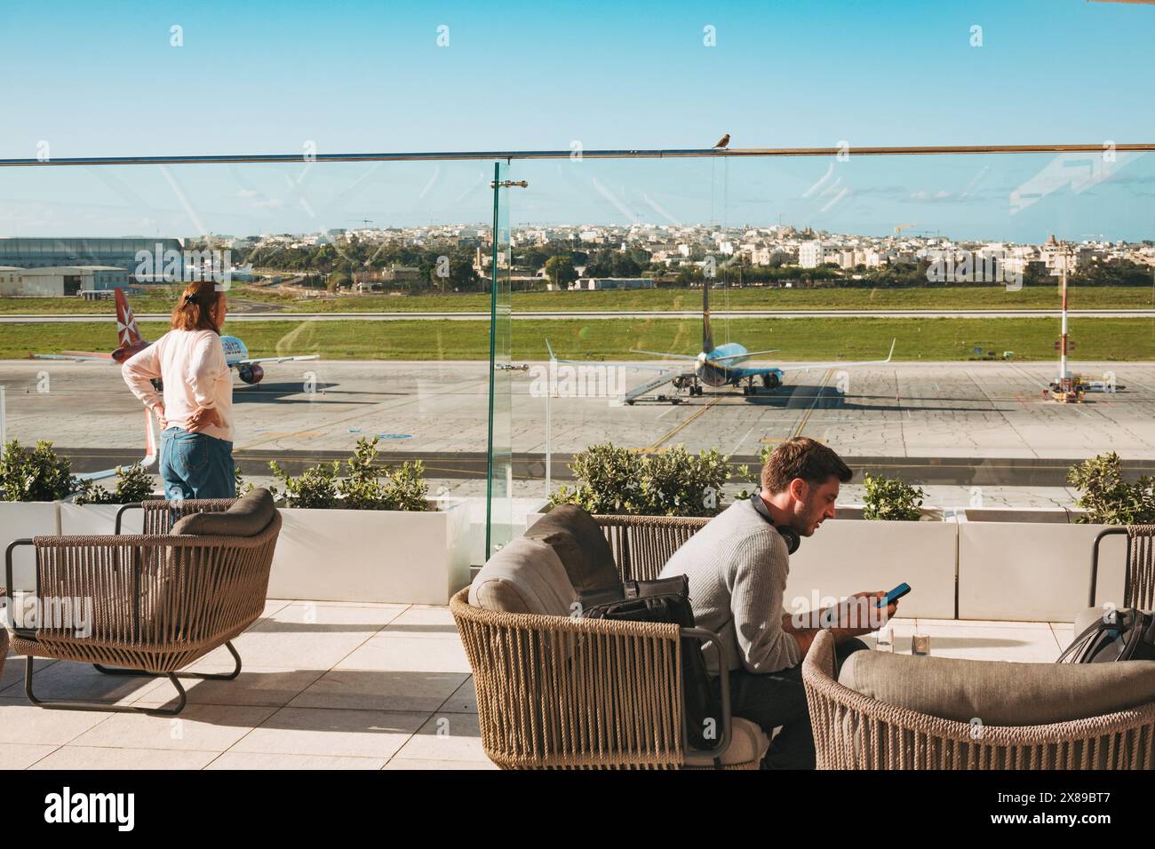 Travelers on the outdoor viewing deck at La Valette Club Lounge at ...