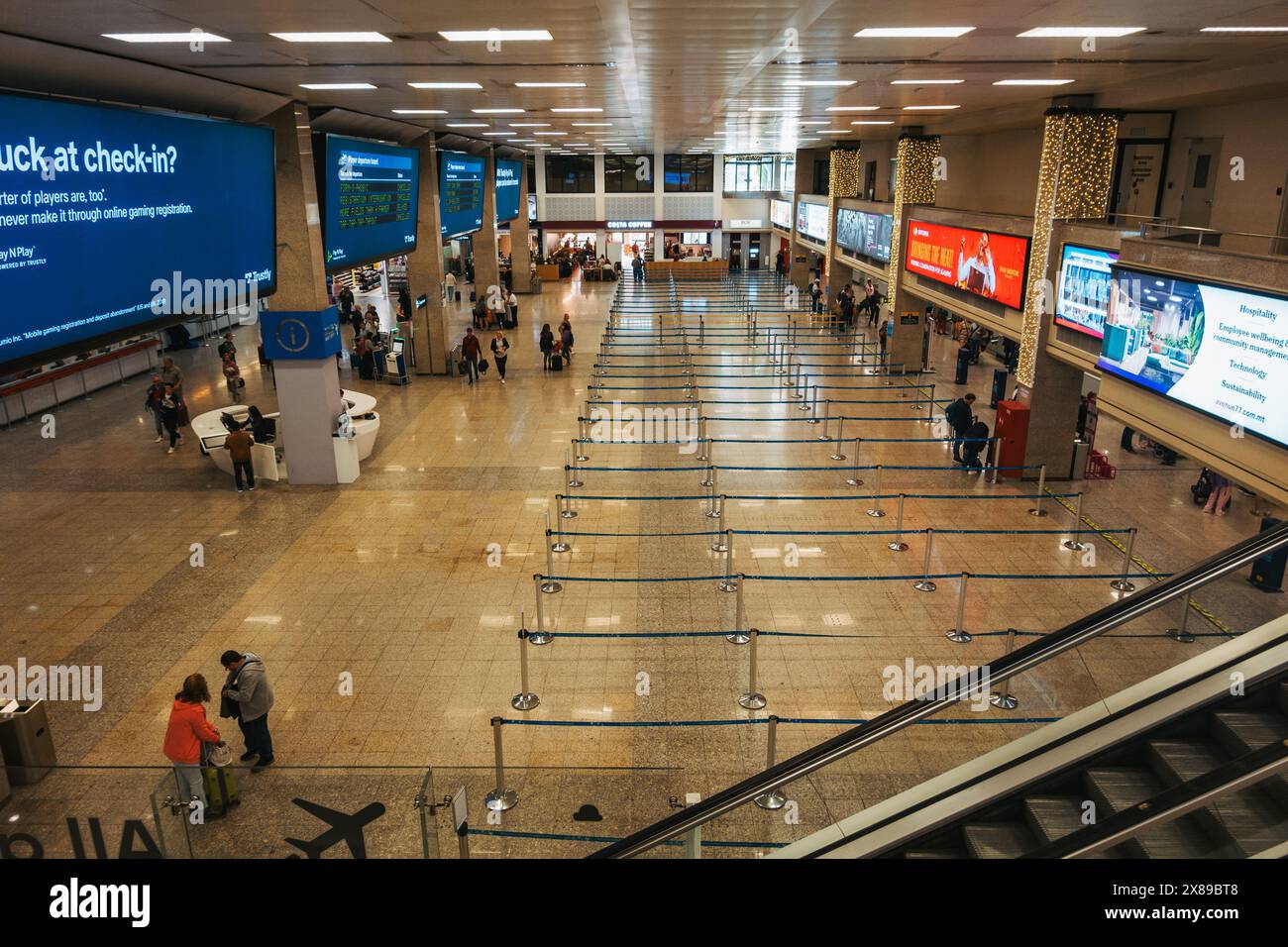 empty check-in lanes at Malta International Airport departures area ...