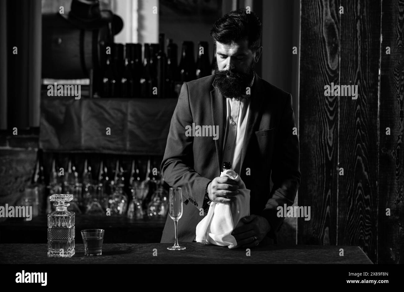 Handsome bearded barman with long beard and mustache with serious face ...