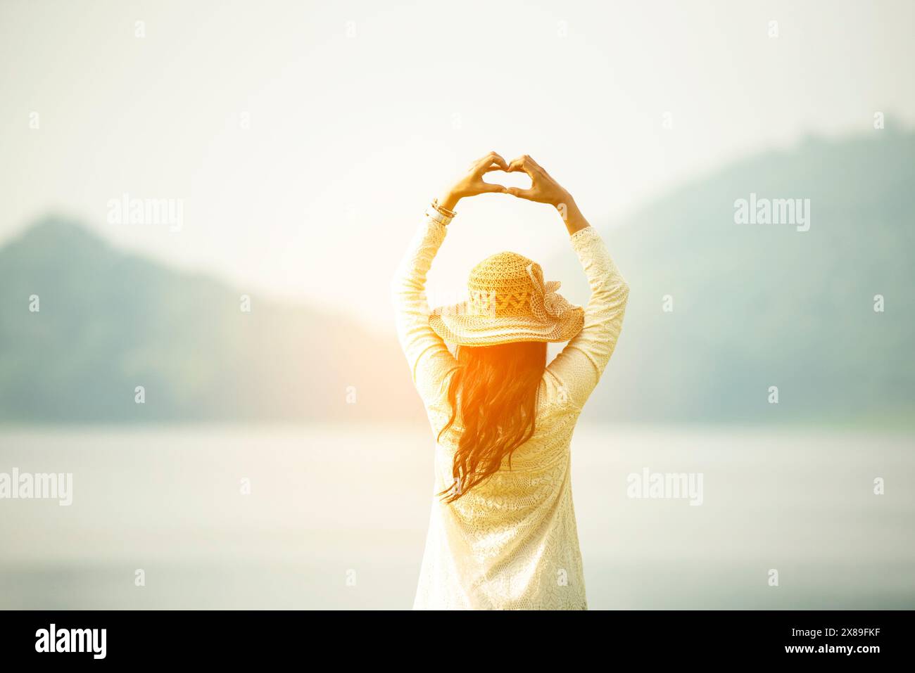 Back side woman feeling fresh freedom positive energy standing grass ...