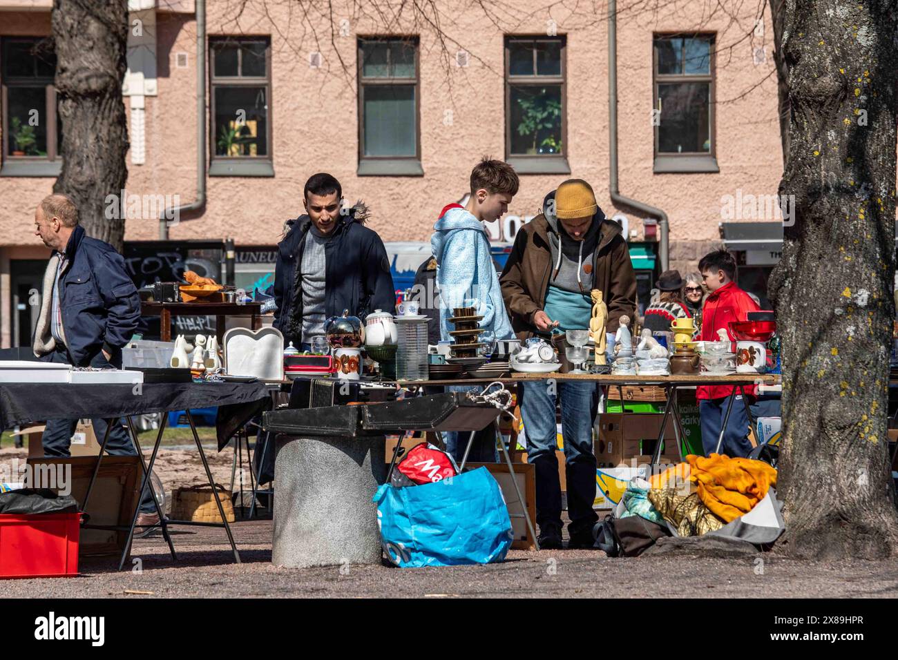 People and secondhand goods at outdoor swap meet held in Karhupuisto in ...