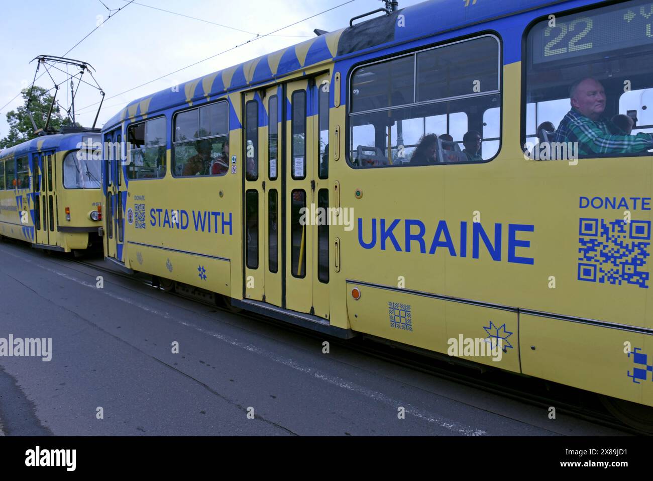 Stand with Ukraine painted tram crossing the historic Legion Bridge or ...