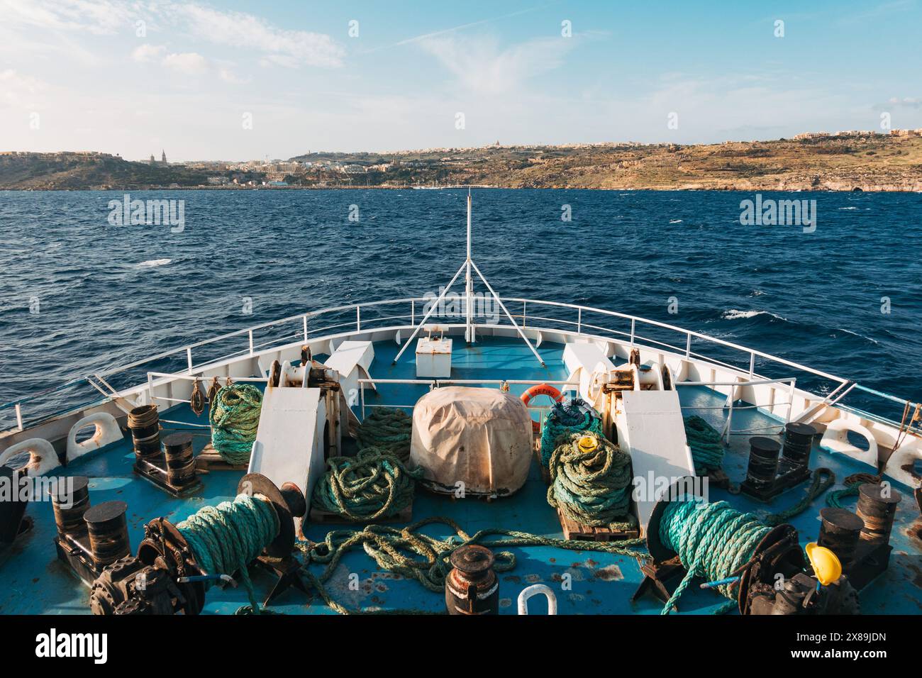 Various equipment and ropes on the bow of a boat as it navigates ...