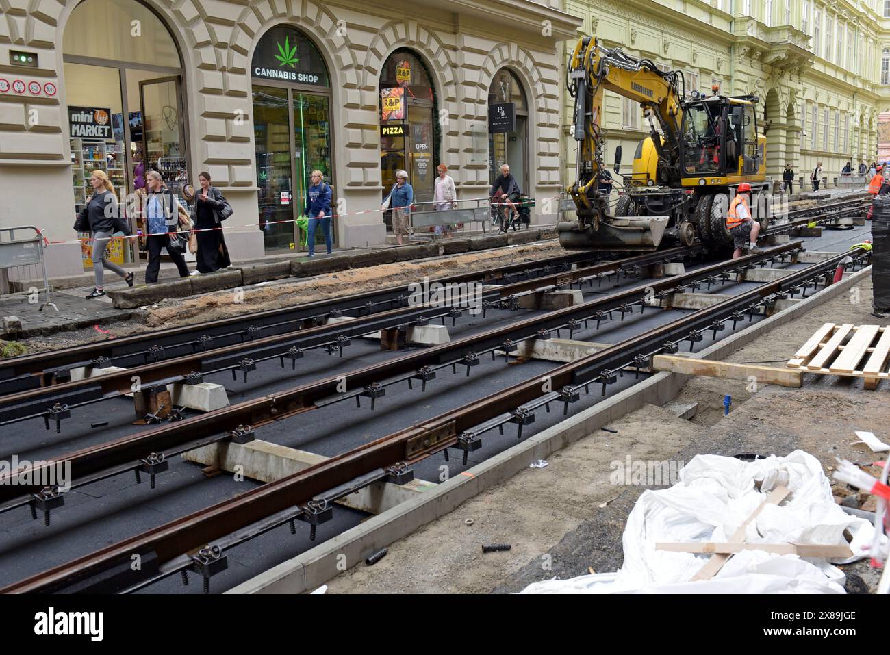 Construction workers relaying tram railway tracks in the street at Senovážné náměstí, Prague ...