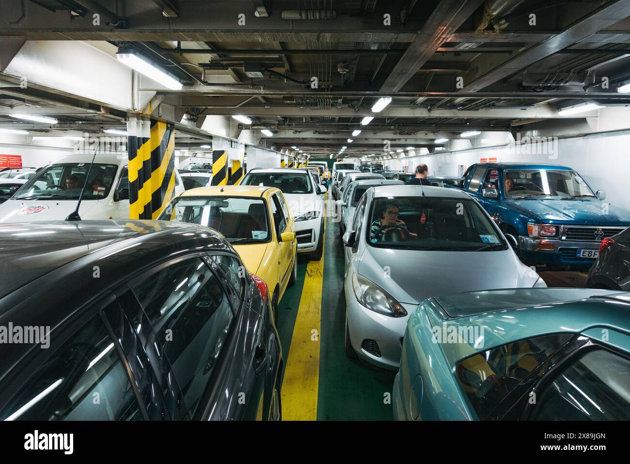 Cars tightly parked together on the lower deck of the Gozo Channel ...