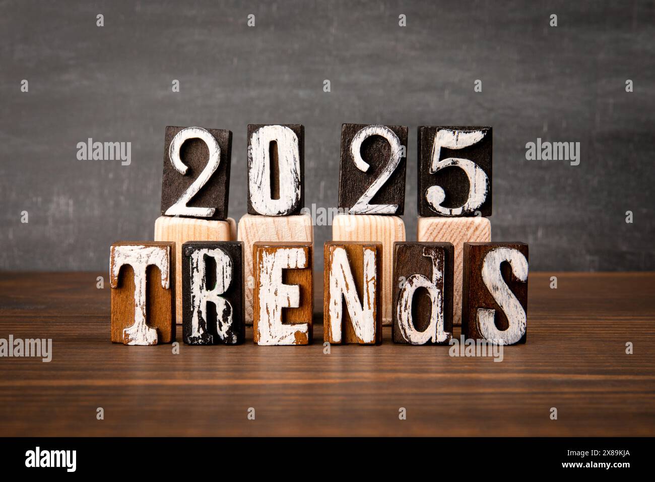 2025 TRENDS. Alphabet blocks on wooden texture table Stock Photo - Alamy