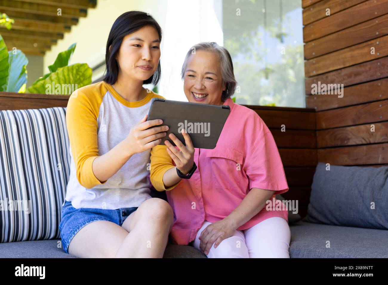At home, Asian middle-aged mother and young adult daughter studying tablet Stock Photo - Alamy