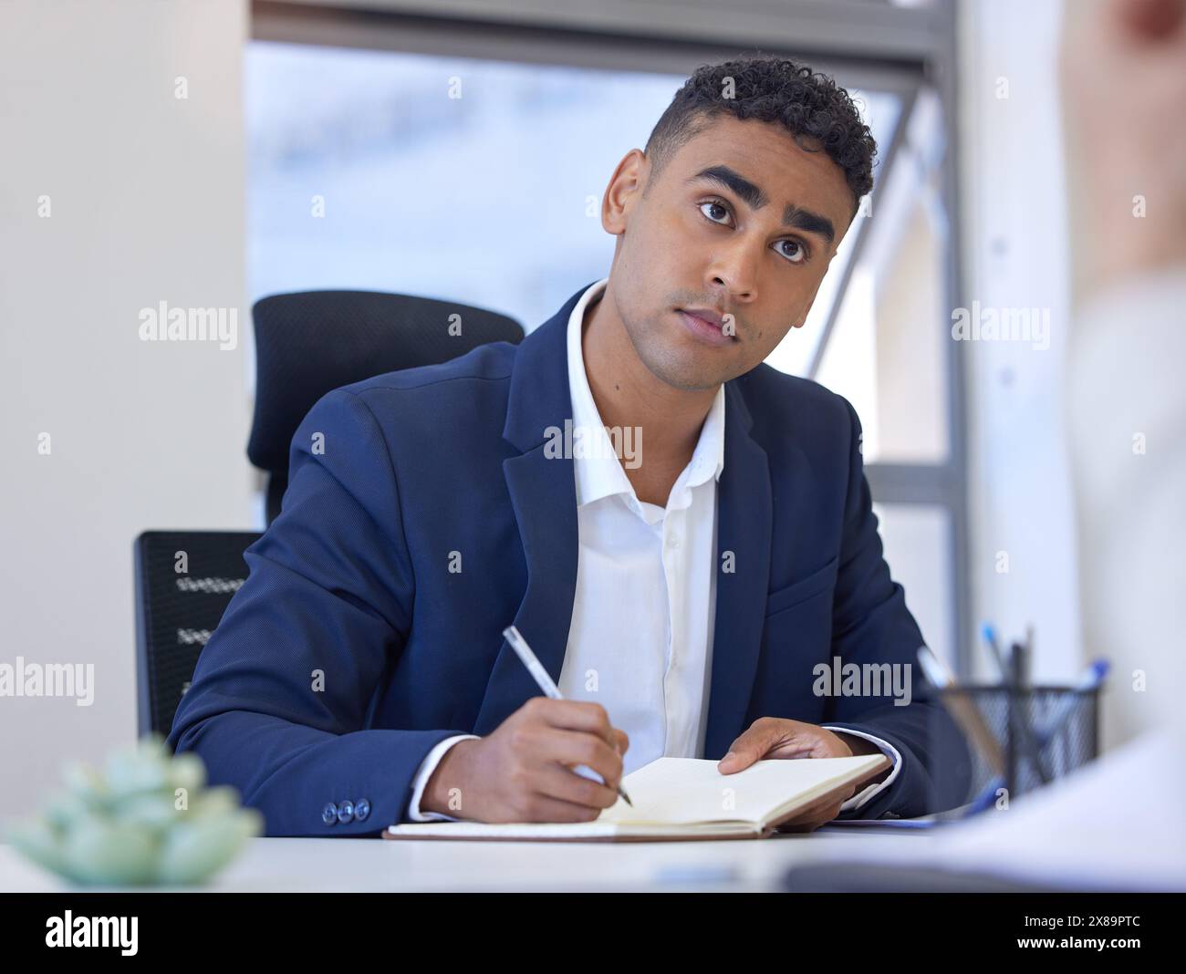Office, book and businessman with listening in meeting for performance ...