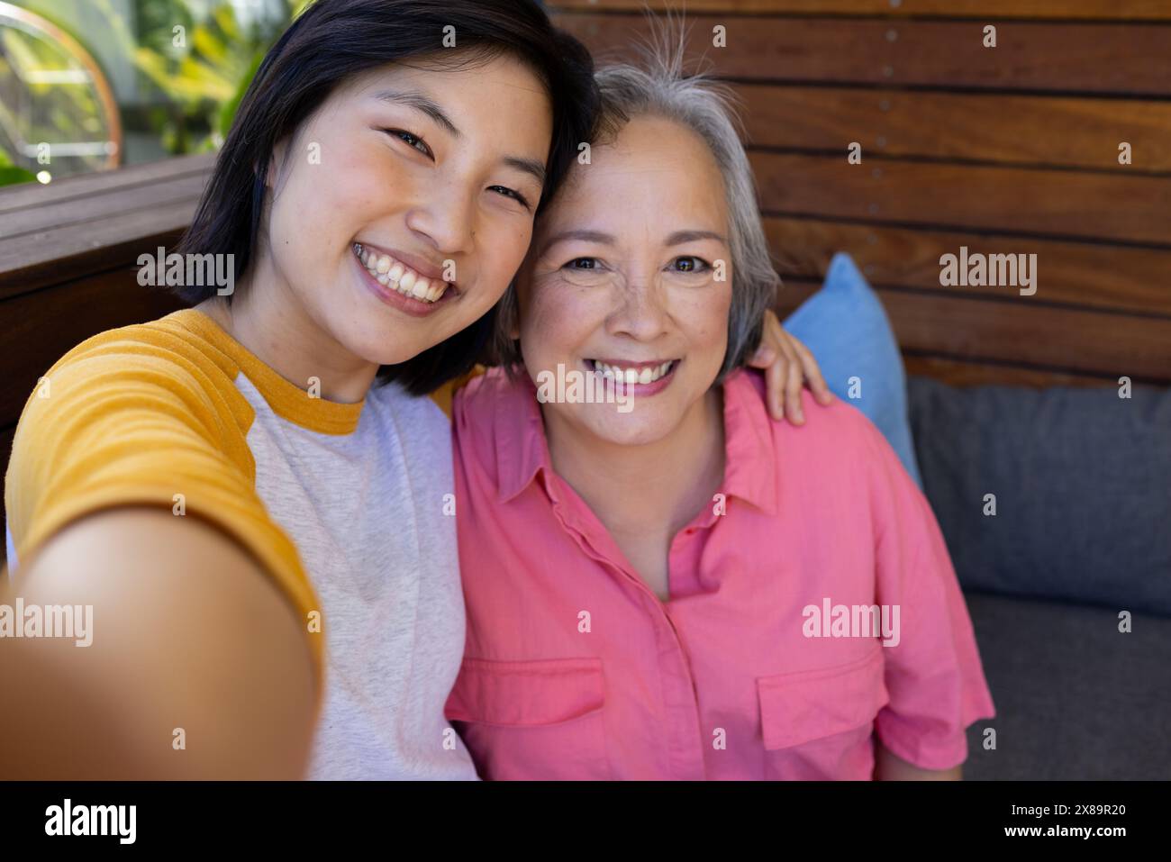 At home, Asian middle-aged mother and young adult daughter smiling for selfie Stock Photo - Alamy