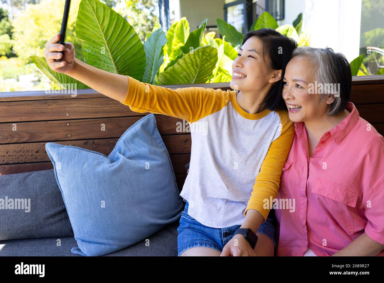 At home, Asian middle-aged mother and young adult daughter taking selfie Stock Photo - Alamy