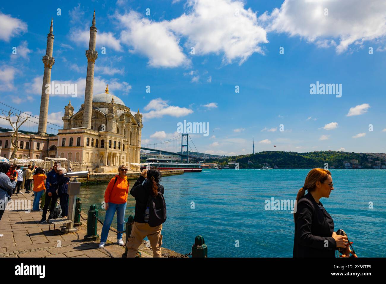 Visit Istanbul concept. Ortakoy Mosque and tourists while sightseeing ...