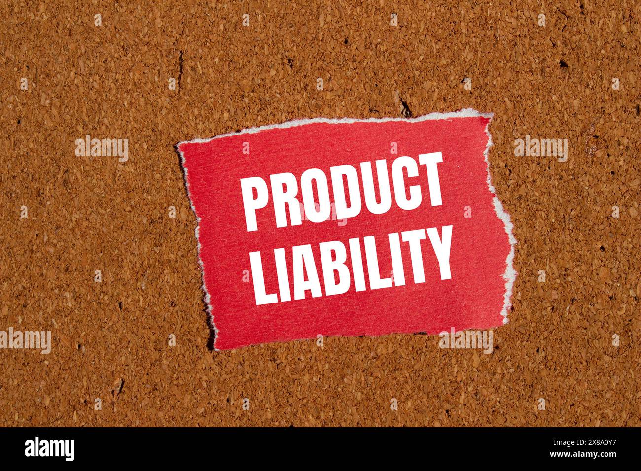 Product liability words written on ripped red paper piece with brown ...