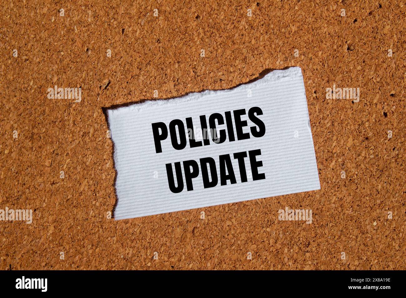Policies update words written on ripped white paper piece with brown ...