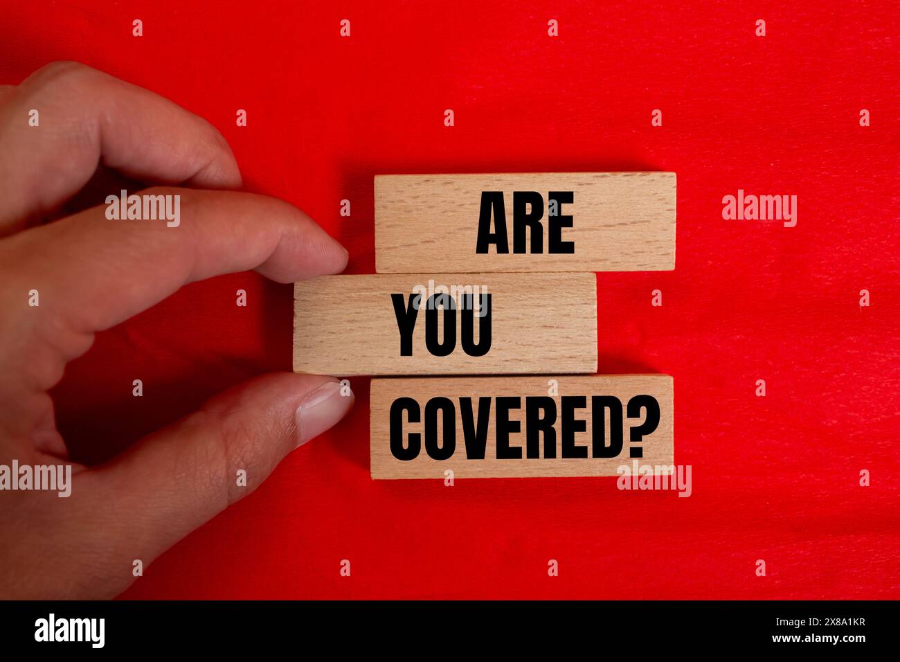 Are you covered ? words written on wooden blocks with red background ...
