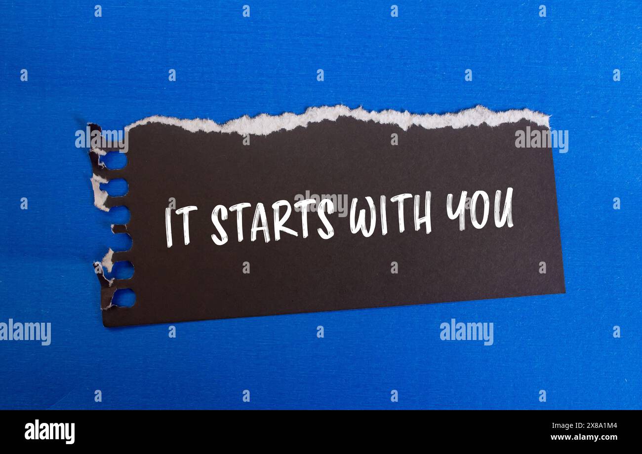 It starts with you words written on ripped black paper piece with blue ...