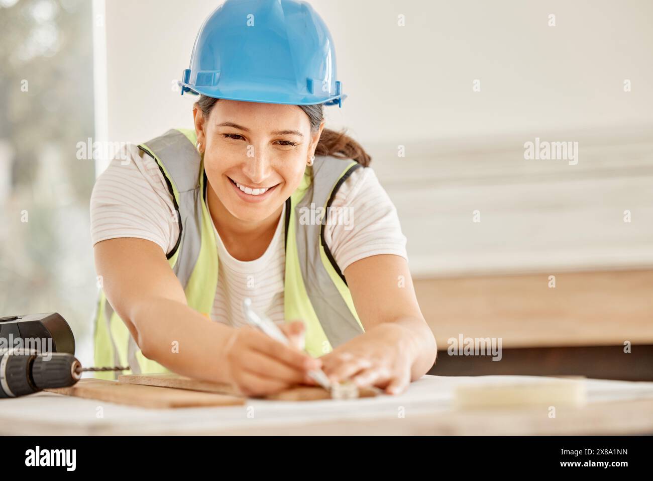 Construction, woman and plank on table to measure, accuracy and check ...