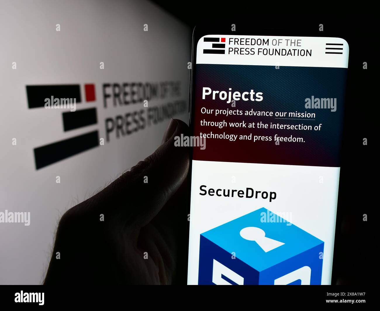 Person holding smartphone with webpage of organisation Freedom of the ...