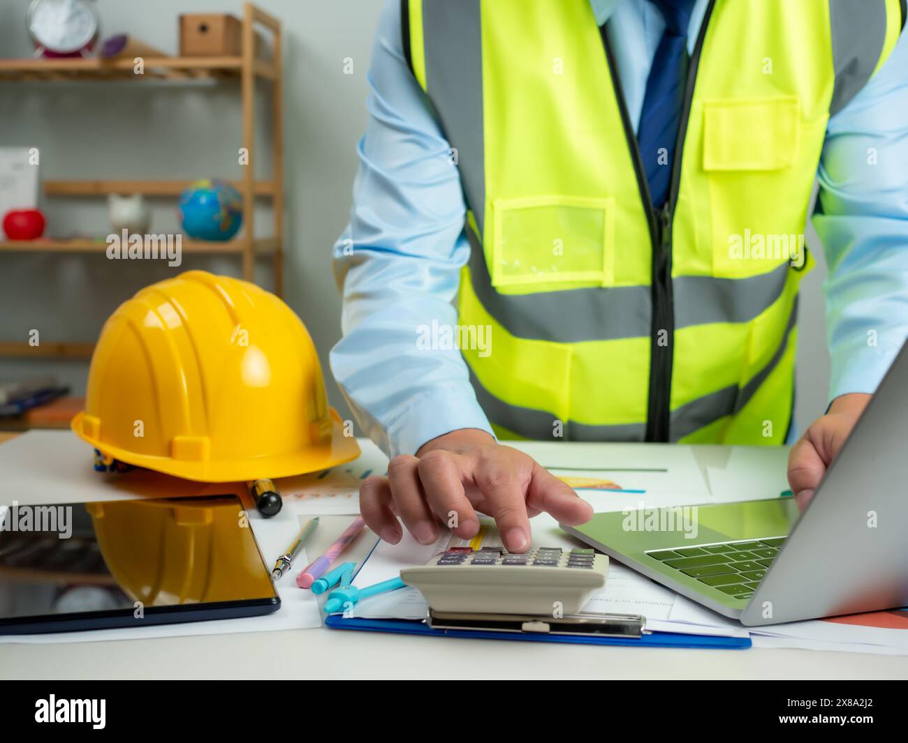 Architect or engineer using computer to work on desk, Cost calculation ...