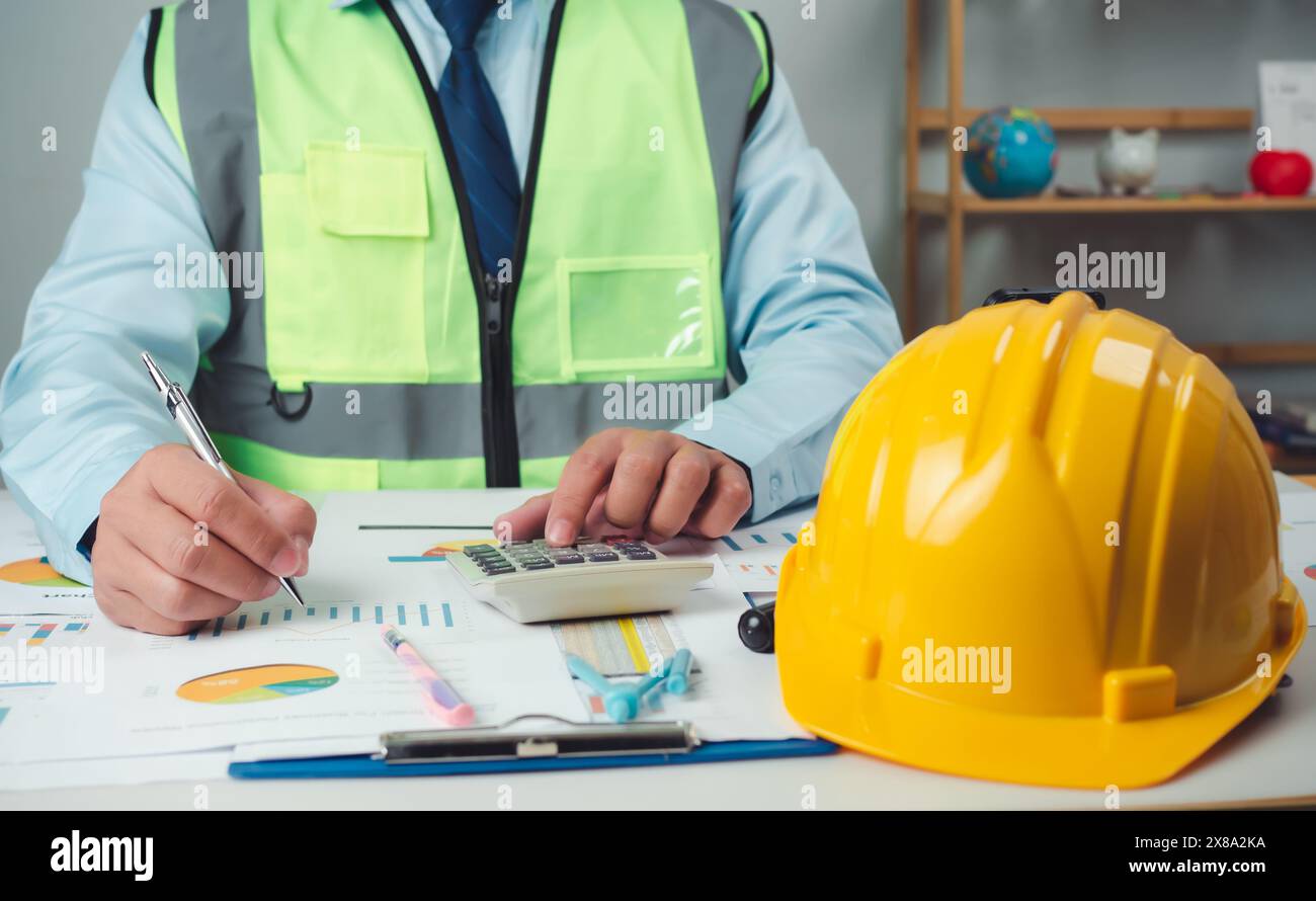 Architect or engineer sitting at desk in office, Cost calculation ...