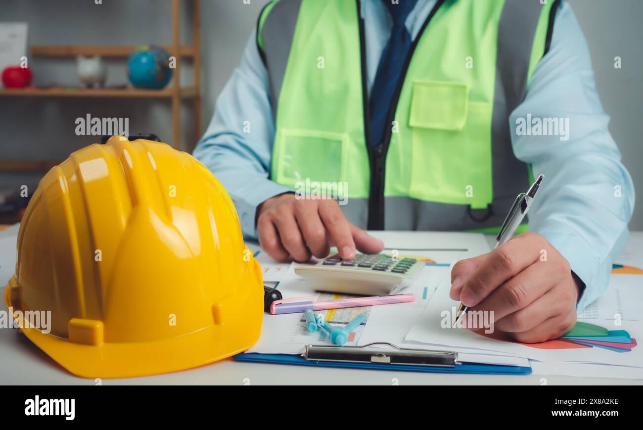 Architect or engineer sitting at desk in office, Cost calculation ...