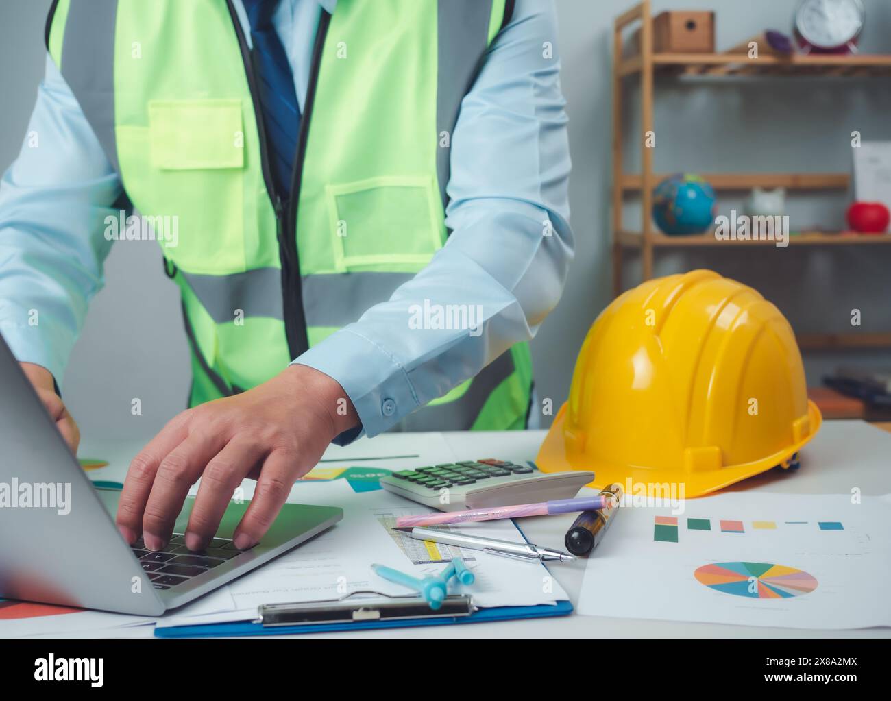 Architect Or Engineer Using Computer To Work On Desk Cost Calculation