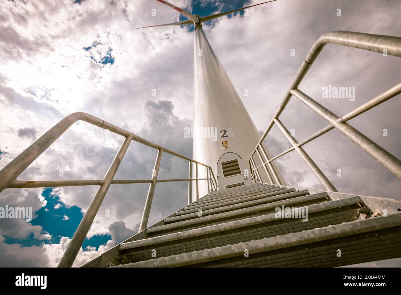 Low angle view of entrance, stairs with doorway into large wind power ...