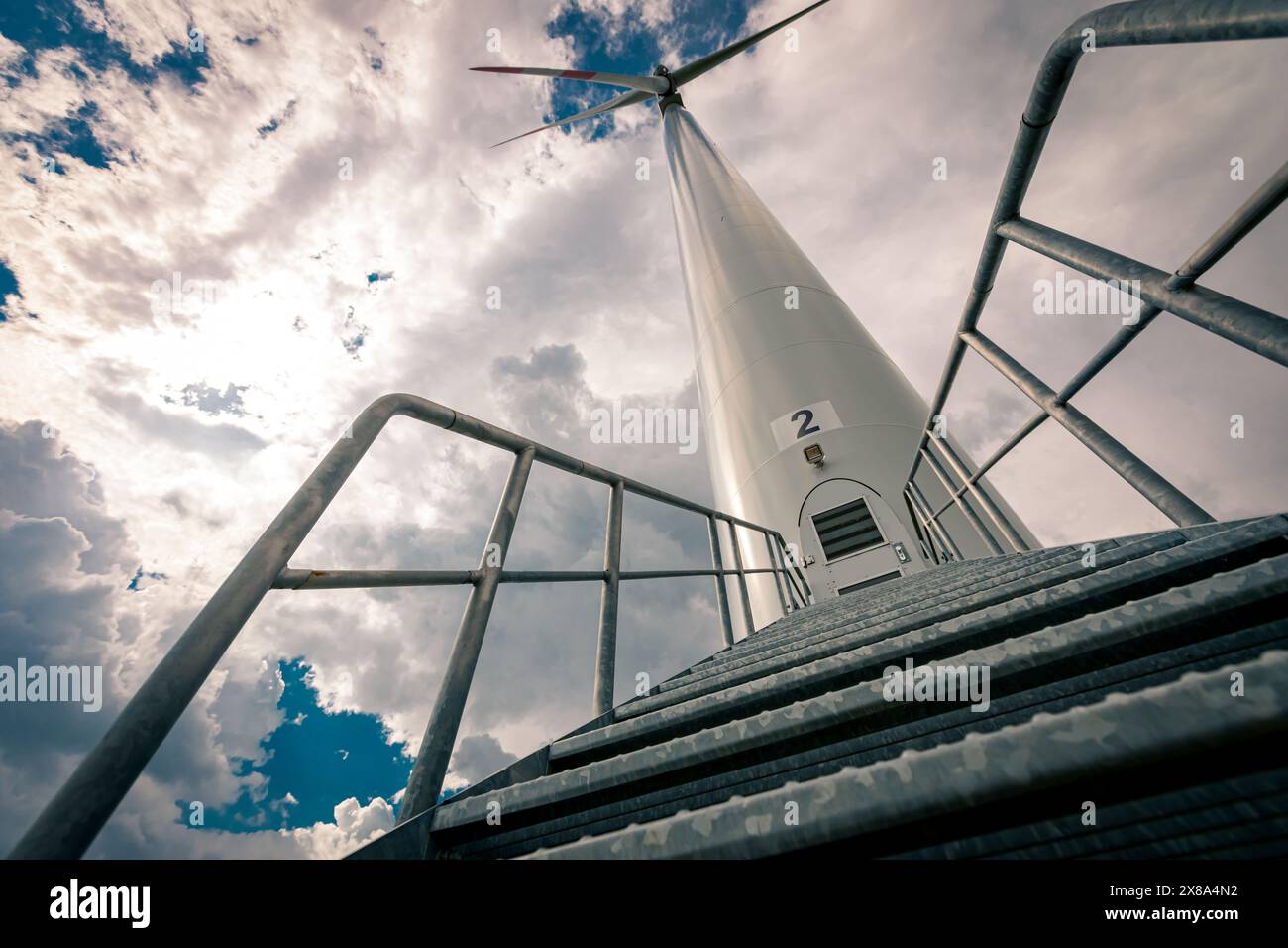 Low angle view of entrance, stairs with doorway into large wind power ...