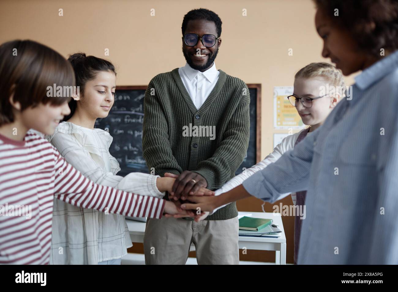Group of ethnically diverse boys and girls and their young teacher ...