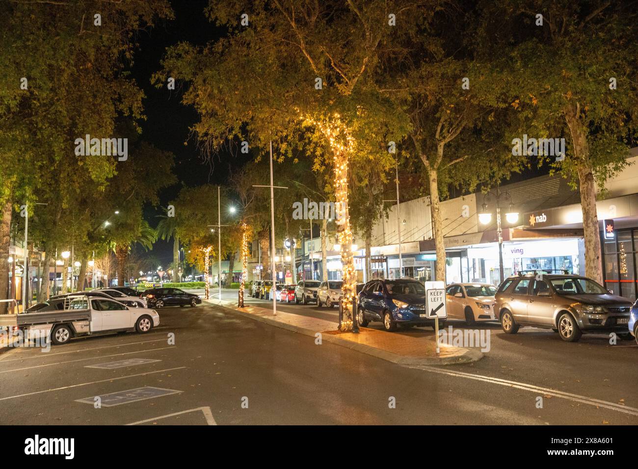 Tamworth city centre at dusk, street lamps light Peel street, New South ...