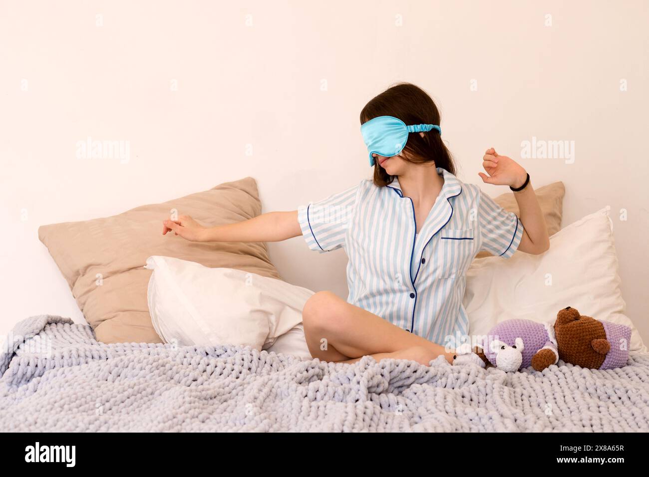Teenage girl stretching in bed after waking up. Good morning Stock ...