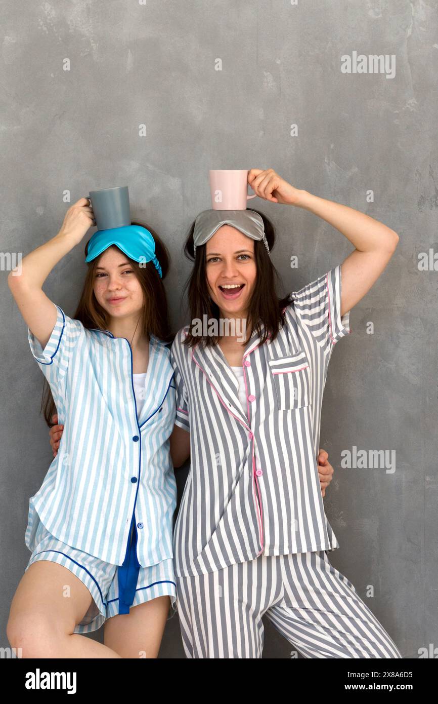 Mother and daughter in pajamas playing balancing game at sleepover ...