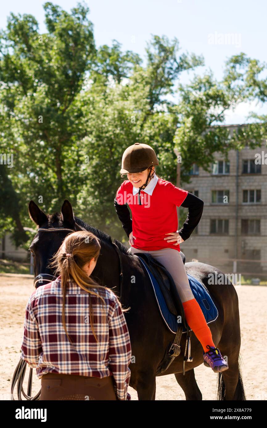 Black child riding horse helmet hi-res stock photography and images - Alamy