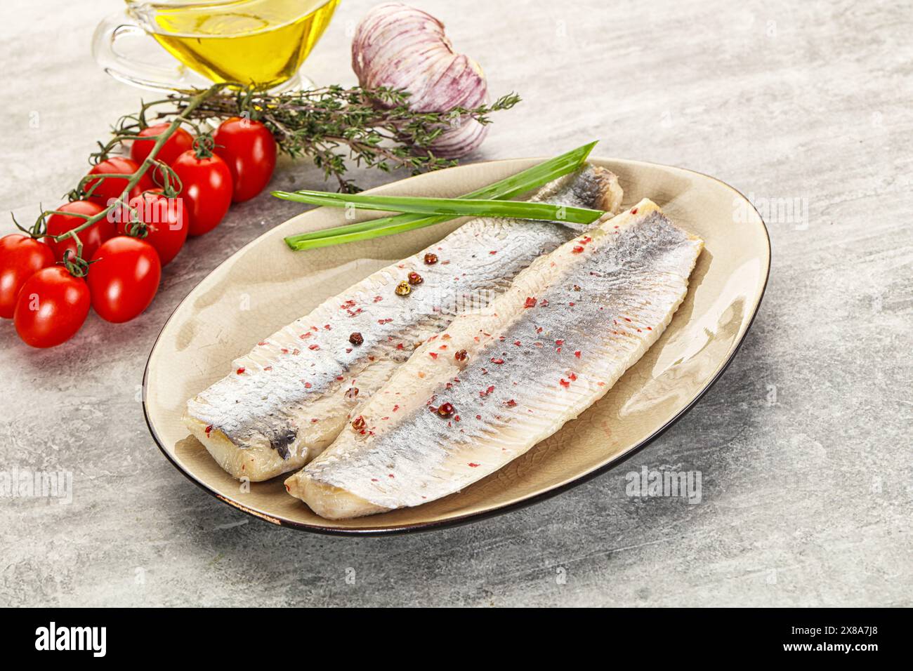 Marinated salted herring fillet with green onion Stock Photo - Alamy