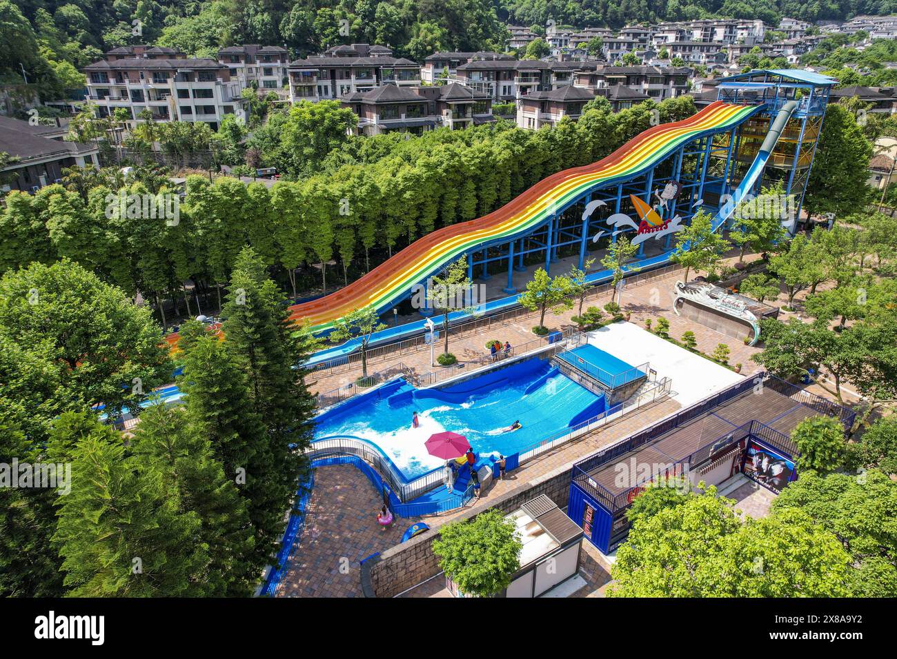 Aerial photo shows people playing at a water park to escape the heat in ...