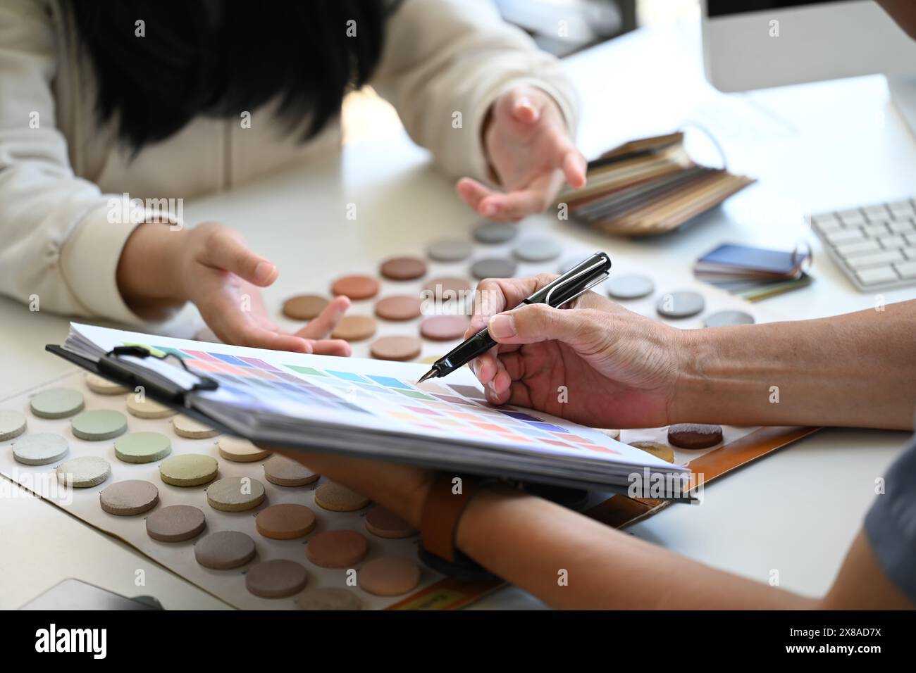 Female customer choosing paint color from samples for the house during ...
