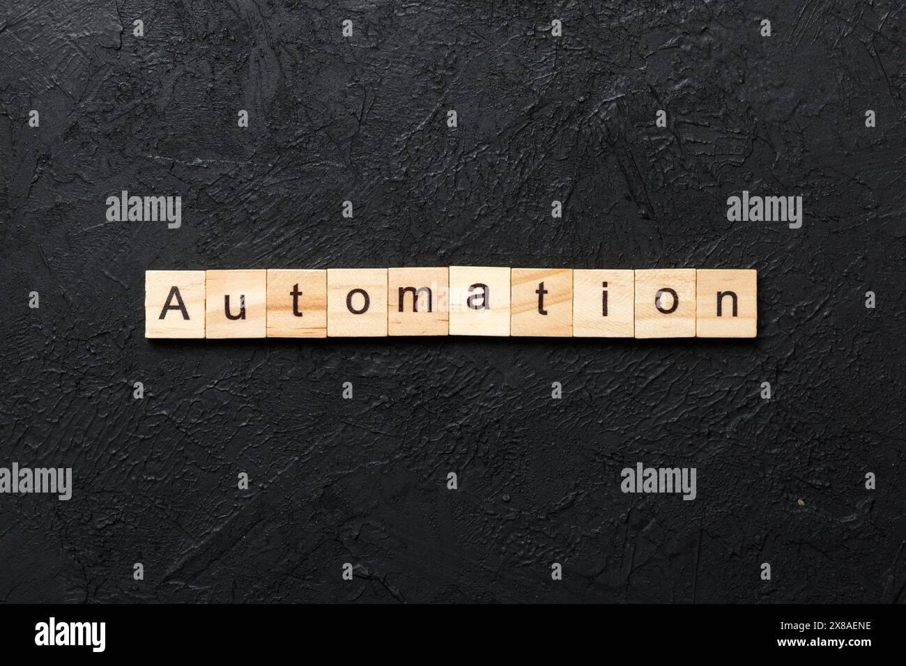 Automation word written on wood block. Automation text on cement table for your desing, concept ...