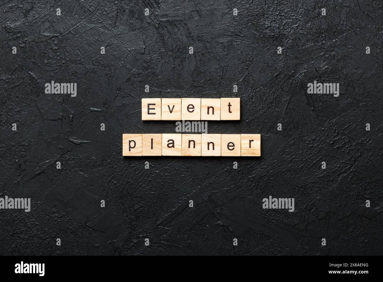 EVENT PLANNER word written on wood block. EVENT PLANNER text on cement ...