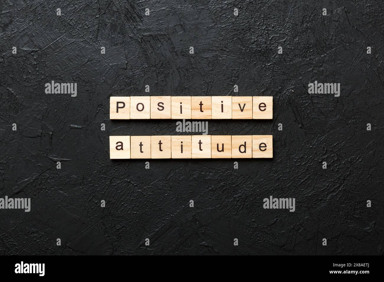Positive Attitude word written on wood block. Positive Attitude text on ...