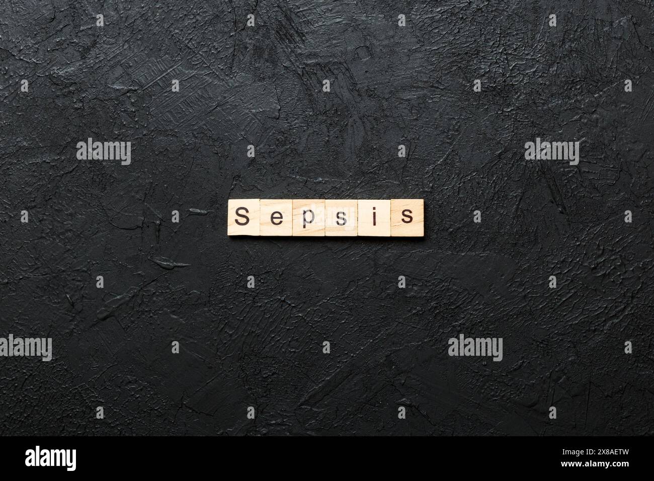 Sepsis word written on wood block. Sepsis text on cement table for your ...