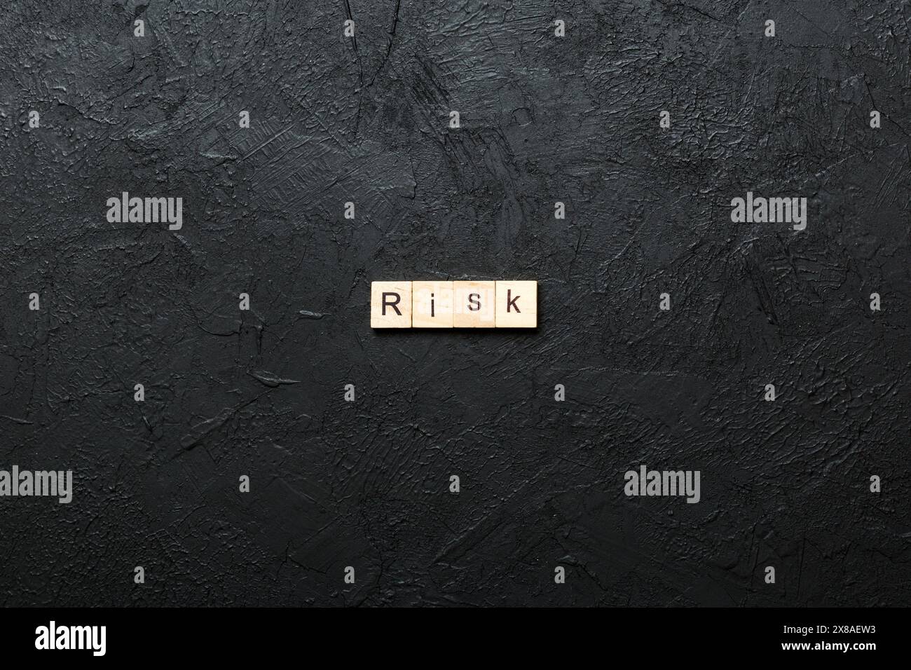 Risk word written on wood block. Risk text on cement table for your ...