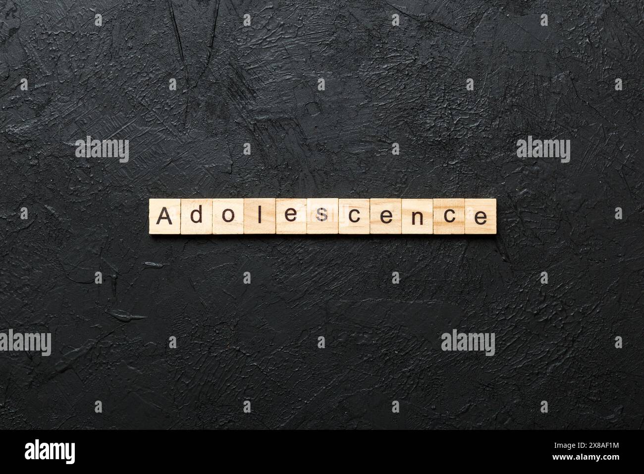adolescence word written on wood block. adolescence text on table ...