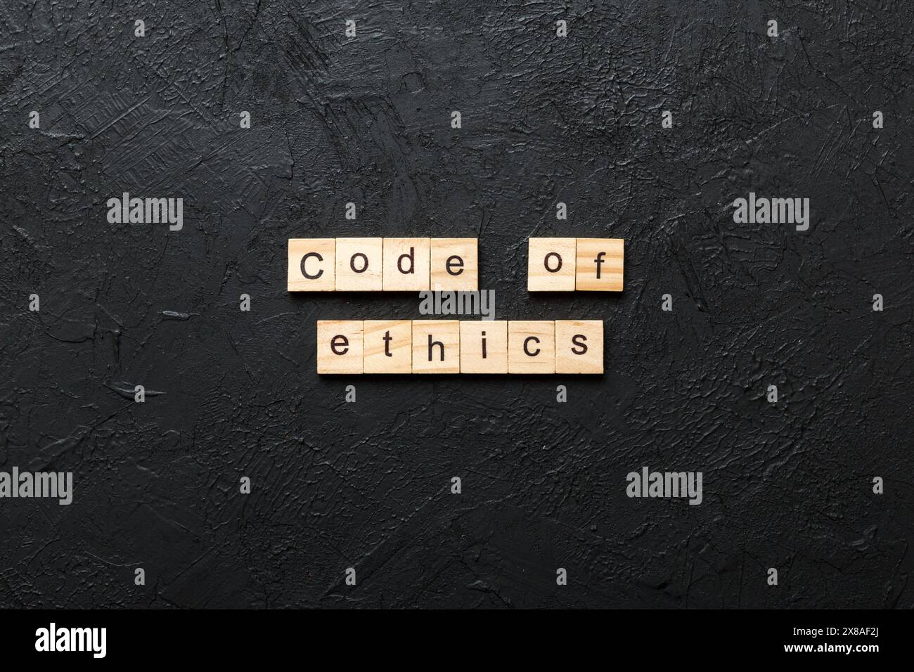 code of ethics word written on wood block. code of ethics text on table ...